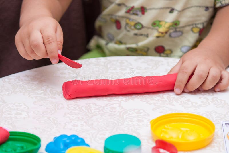Child Hands Playing with Colorful Clay. Child Play with Plasticine ...