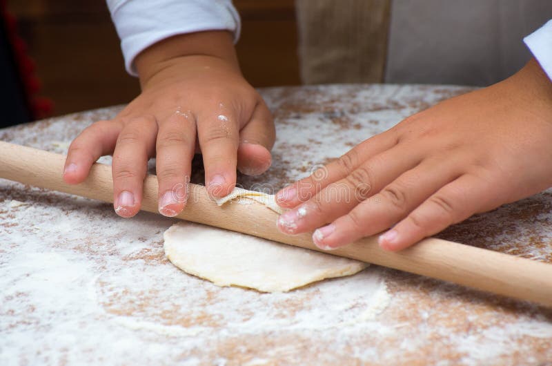 Child Hands Rolling Dough with Rolling Pin on Wooden Table Stock Image ... Child Hands Rolling Dough with Rolling Pin on Wooden Table Stock Image ...