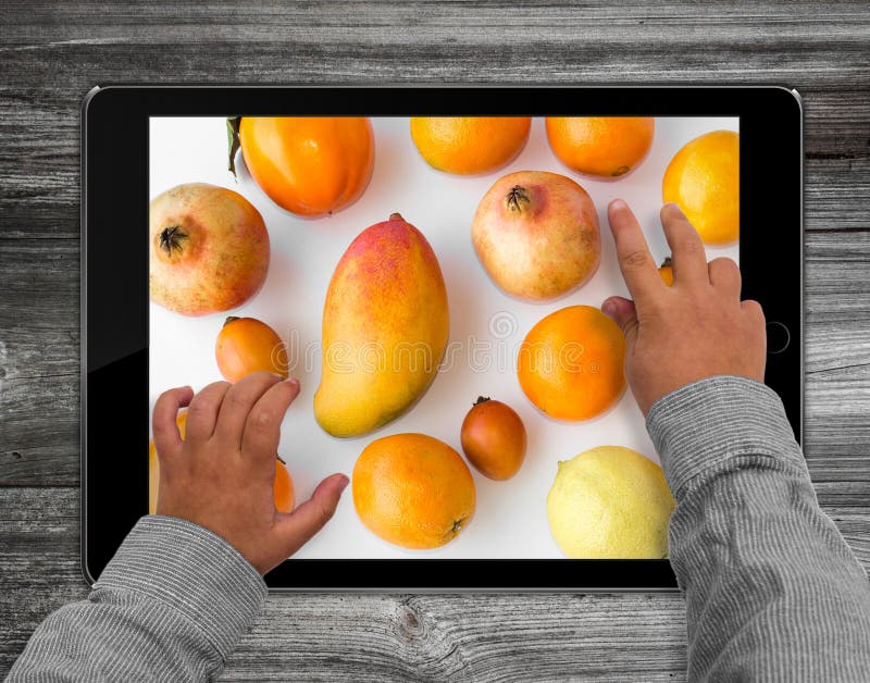 Child Hands on Tablet Computer with Mixed Fruit Picture Stock Image ...