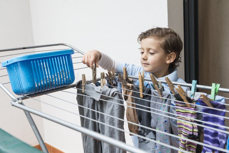 Child hanging clothes stock image. Image of hygiene - 178486013