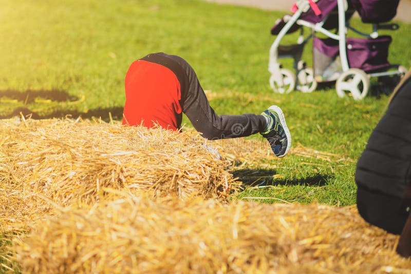 A Child Happily Tumbling in a Haystack Stock Photo - Image of healthy ...