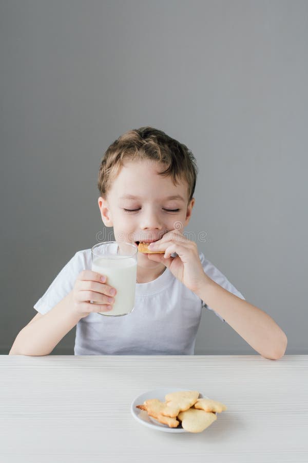 The Child is Happy To Eat Homemade Biscuits with Milk Stock Image ...