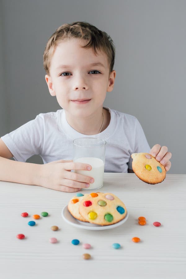 The Child is Happy To Eat Homemade Biscuits with Milk Stock Image ...