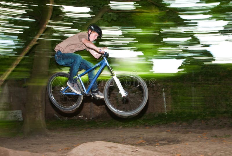 Child Has Fun Jumping with the Bike Over a Ramp Stock Image - Image of ...