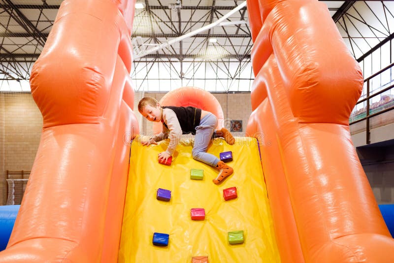 Child Has Fun Jumping in an Inflatable Castle at a Children`s Fair ...