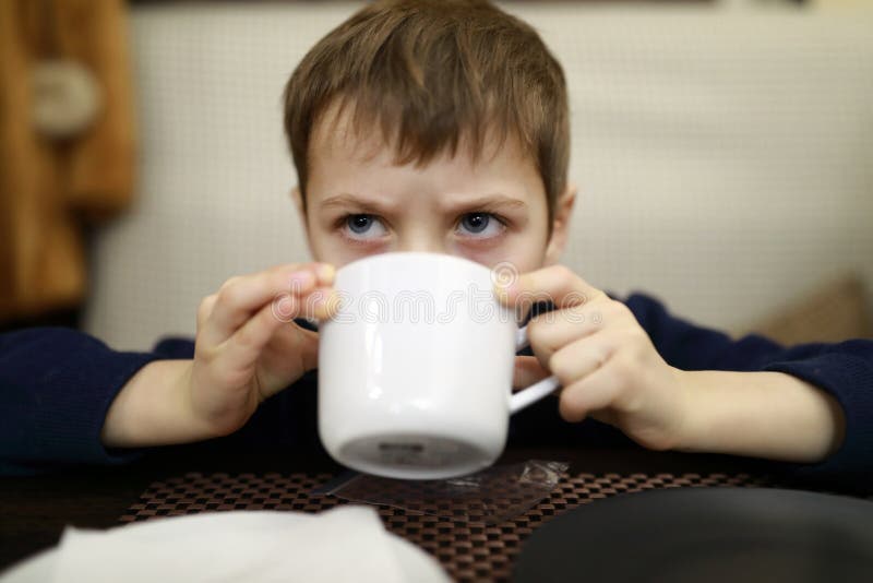 Child Has Tea in Restaurant Stock Photo - Image of holding, cafe: 211173296