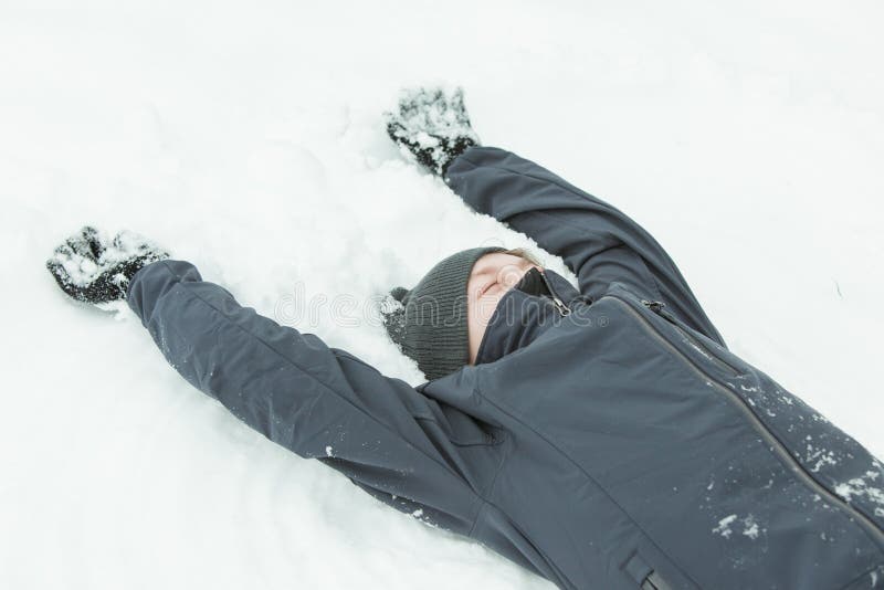 Child in Hat and Coat Laying Down in Snow Stock Image - Image of ...