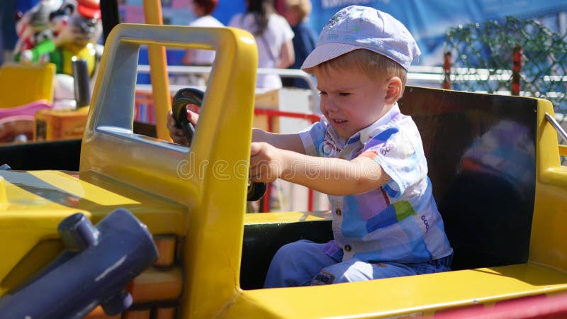 Child Having Fun at an Amusement Park.Riding the Car Stock Photo ...