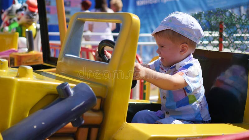 Child Having Fun at an Amusement Park.Riding the Car Stock Image ...