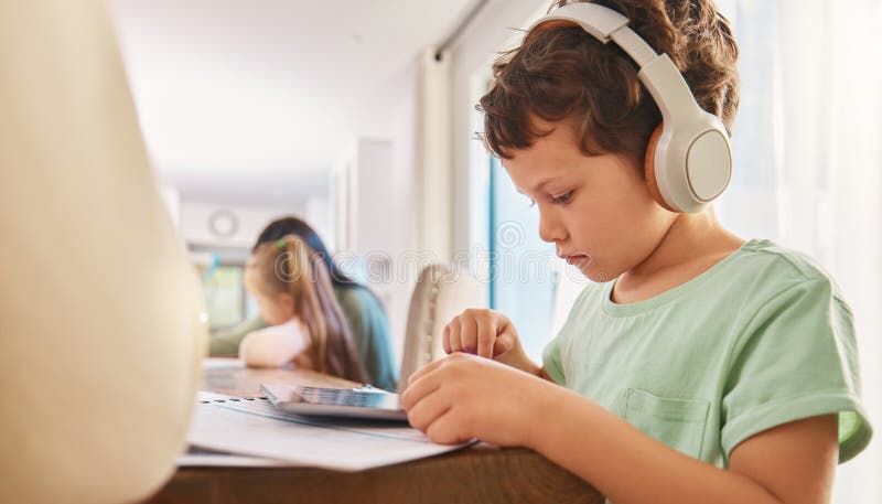 Child, Headphones and Tablet for Education and Learning at a Home Table ...