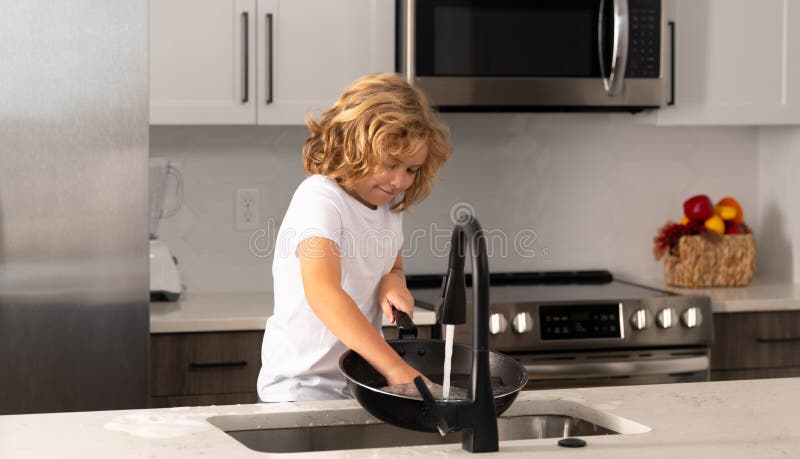 Child Help in Washing Dishes at Kitchen. Cleaning Dishwashing during ...