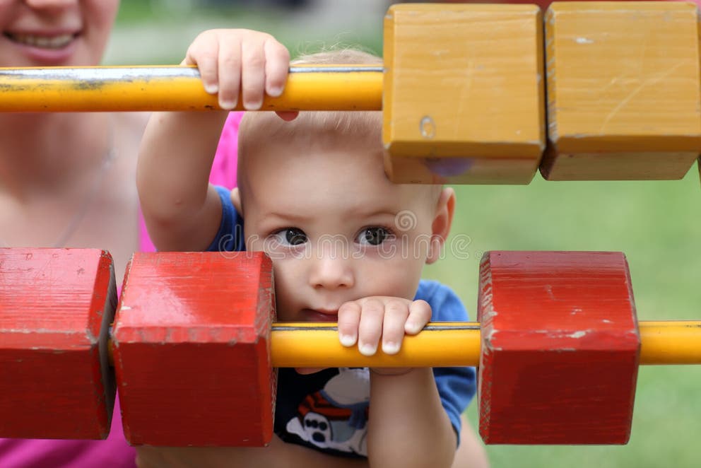 Child hiding behind blocks stock photo. Image of child - 25751420