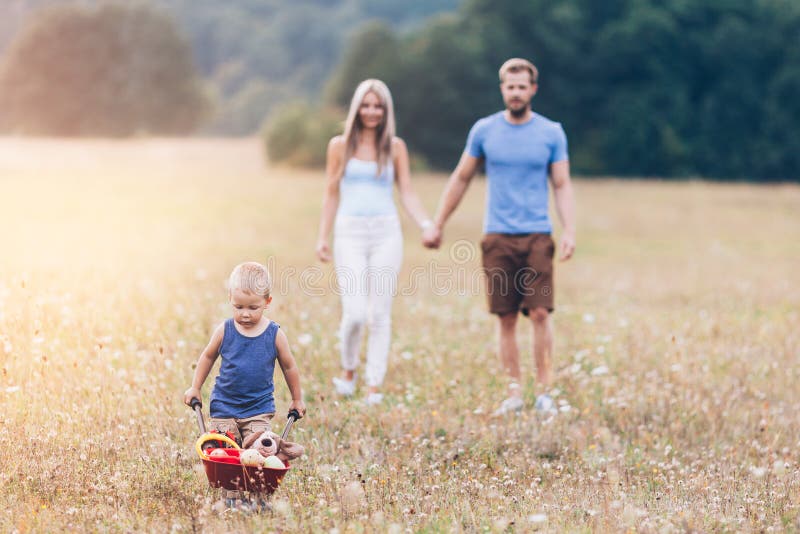 Parents Pushing Daughter in Wheelbarrow Stock Image - Image of person ...