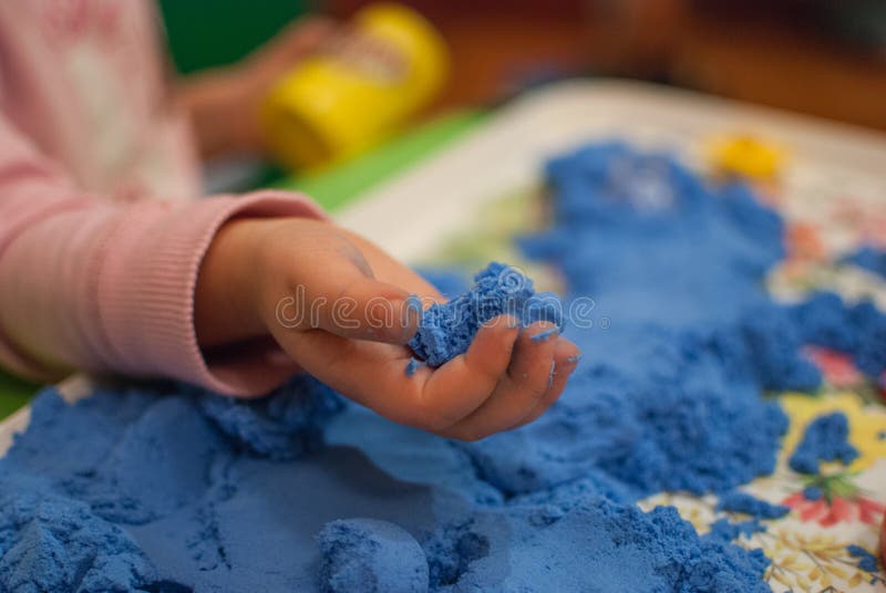 Child holding blue sand stock image. Image of creative - 84959839