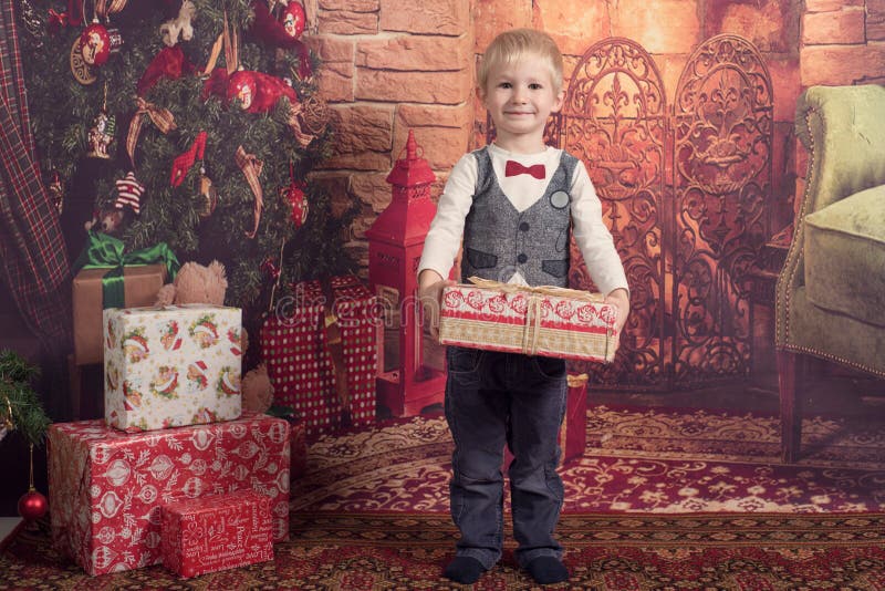 Child holding a gift box stock image. Image of child - 132619991