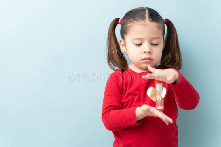 Child Holding a Sand Timer during Timeout Stock Photo - Image of space ...