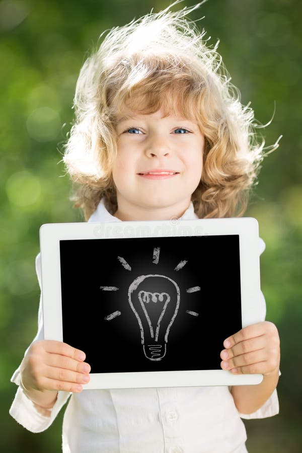 Child holding tablet PC stock image. Image of bulb, happy - 28591909