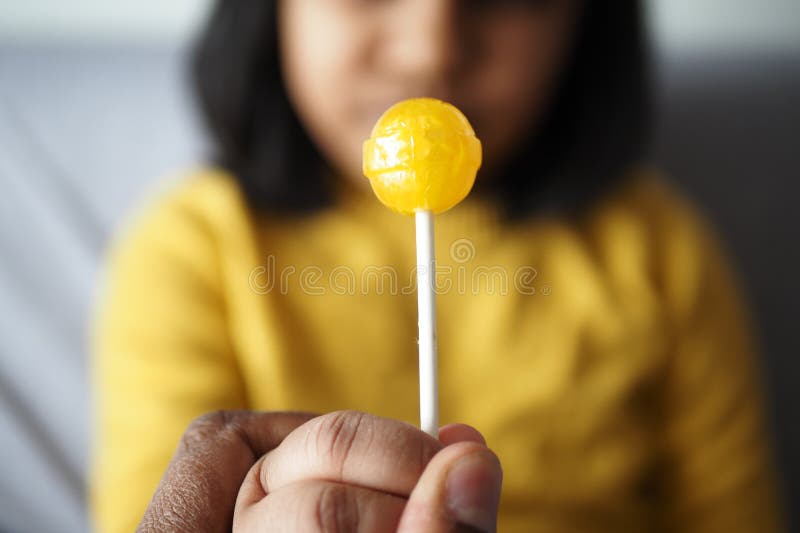 Child Holding Yellow Color Lollipop Candy Stock Image - Image of bright ...
