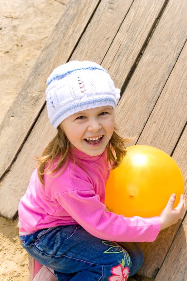 Child holds a ball stock image. Image of cheerful, games - 5036387