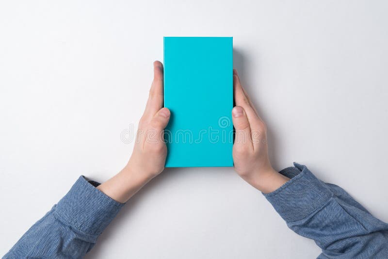 Child Holds Rectangular Blue Box on White Background. Top View Stock ...
