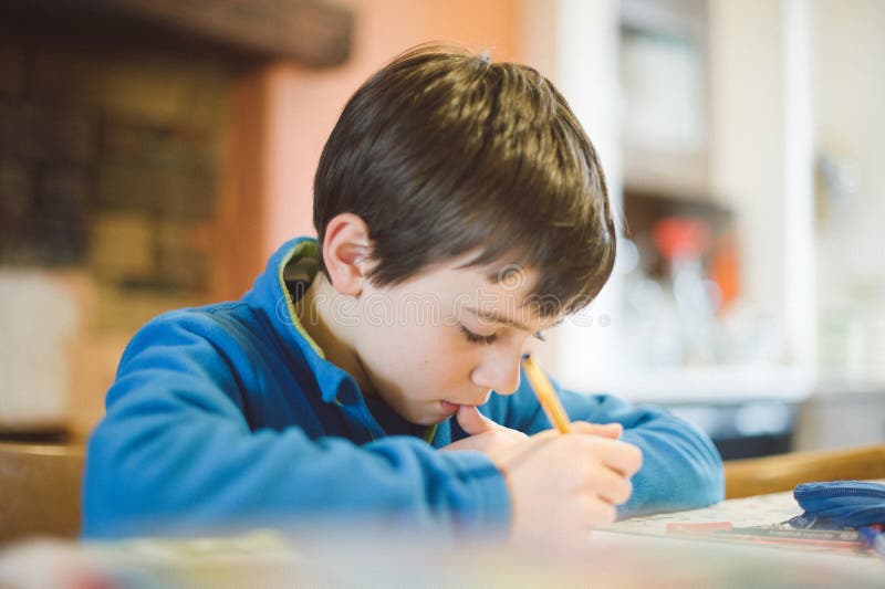 Child at Home Performs Homework by Writing in the Notebook Stock Image ...