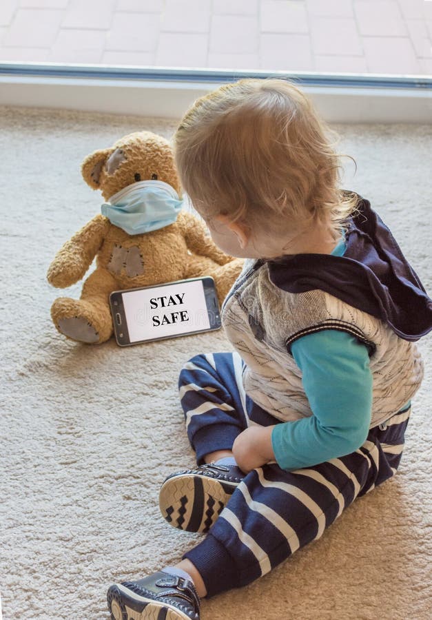 Child in Home Quarantine Playing at the Window with the Phone with Stay ... Child in Home Quarantine Playing at the Window with the Phone with Stay ...