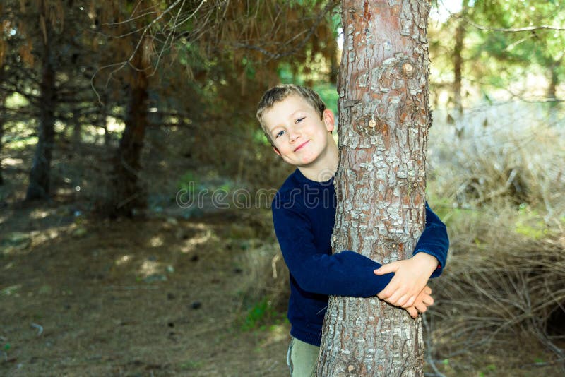 Child Hugging a Tree in a Dark Forest Taking Care of the Planet Stock ...
