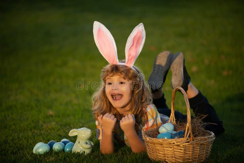 Child Hunting Easter Eggs in Backyard Laying on Green Grass. Child ...