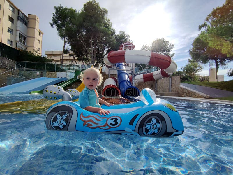 Child on an Inflatable Car Swims in the Pool Stock Photo - Image of ...