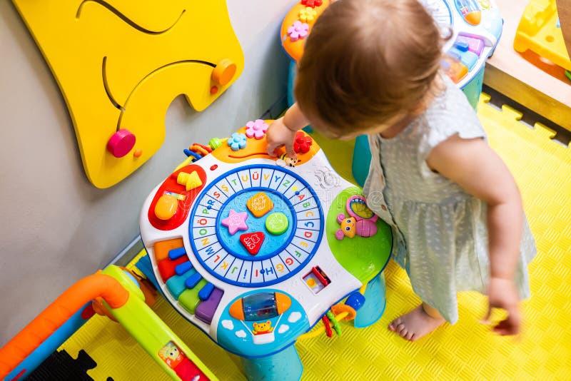 Child Interacting with Educational Toy Table in Vibrant Space. Concept ...