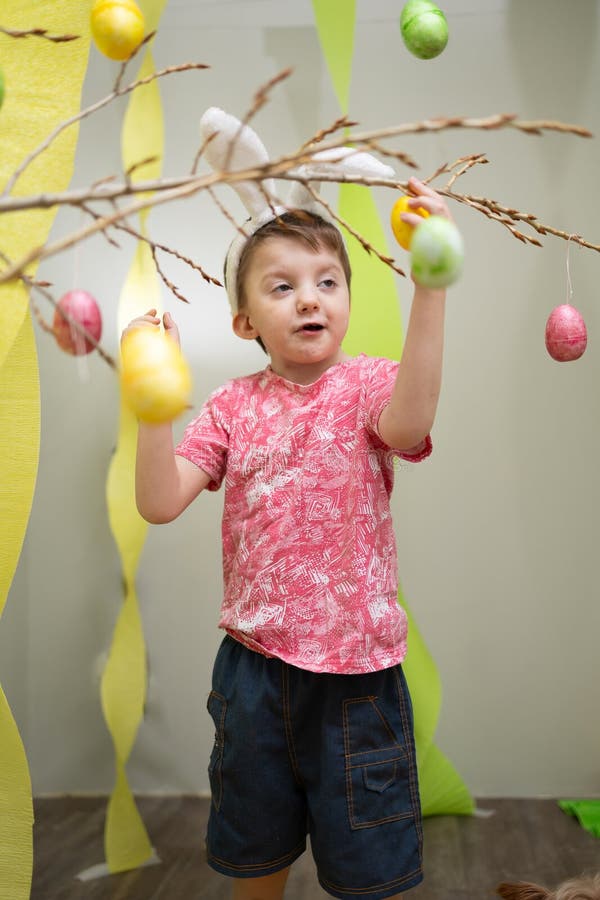 A Child Joyfully Celebrating Easter with Vibrant and Colorful Eggs in a ...