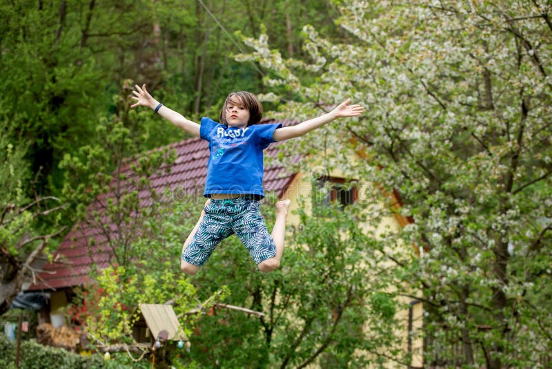 Child, Jumping High on a Trampoline Stock Image - Image of beautiful ...
