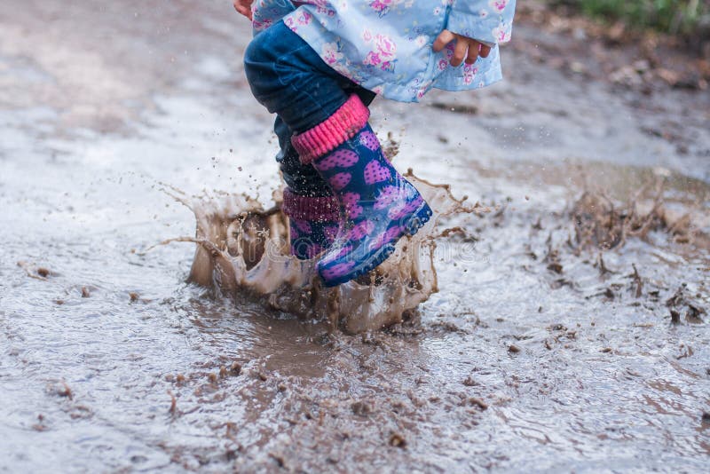 Child Jumping in the Muddy Puddle Stock Image - Image of happy ...