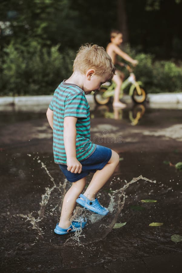 Boy Jumping Puddle Stock Photos - Download 889 Royalty Free Photos