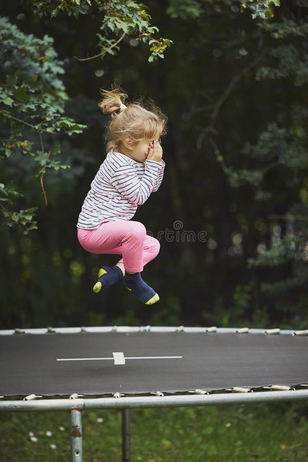 Child Jumping on a Trampoline in the Evening Garden in Denmark Stock ...