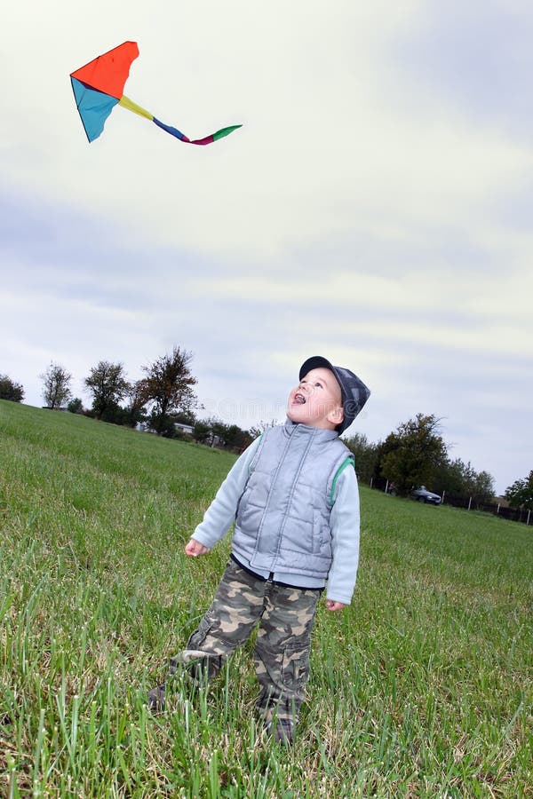Little boy flying a kite stock image. Image of action - 16306569
