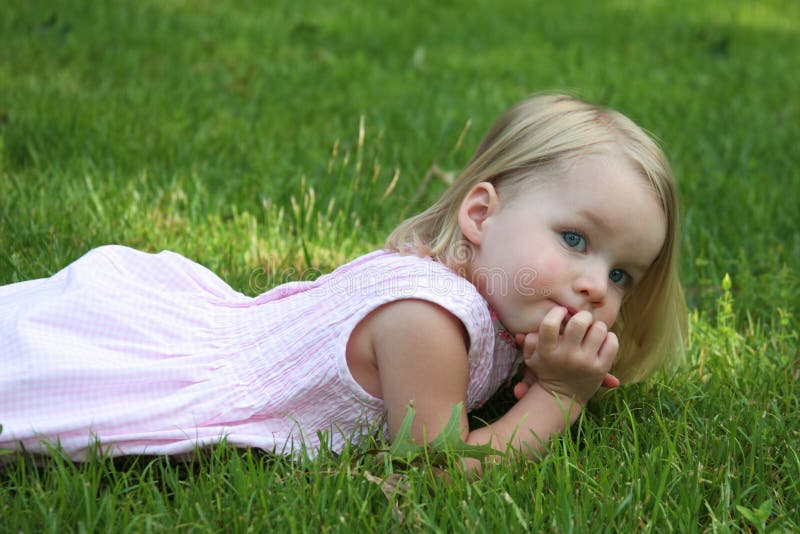 Child laying on grass stock photo. Image of outdoors, laying - 250706