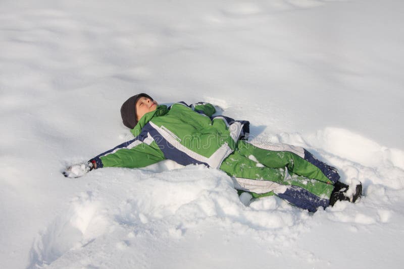 Child laying on snow stock photo. Image of season, frost - 11145950