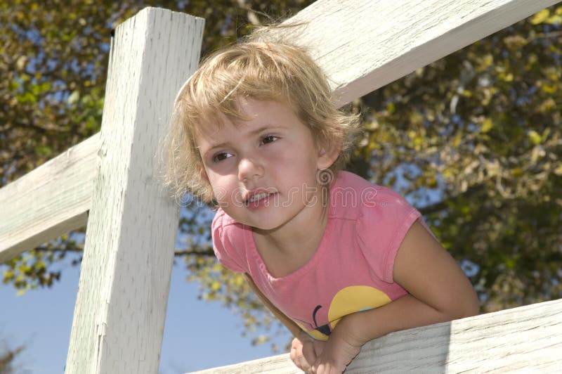 Child leaning over a fence stock photo. Image of toddler - 6939434