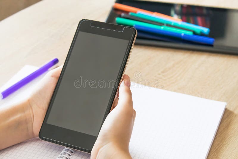 A Child is Learning Distance Learning Lessons on a Mobile Phone Stock ...
