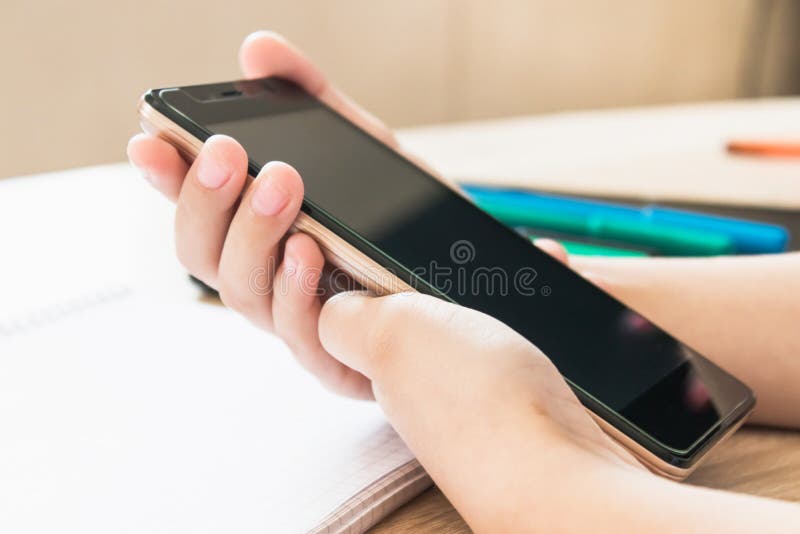 A Child is Learning Distance Learning Lessons on a Mobile Phone Stock ...