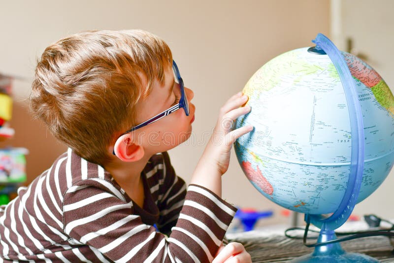 Child Learning Geography with Globe at Home Stock Photo - Image of ...