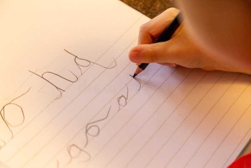 A Child Learning To Write on Lined Paper Stock Image - Image of ...