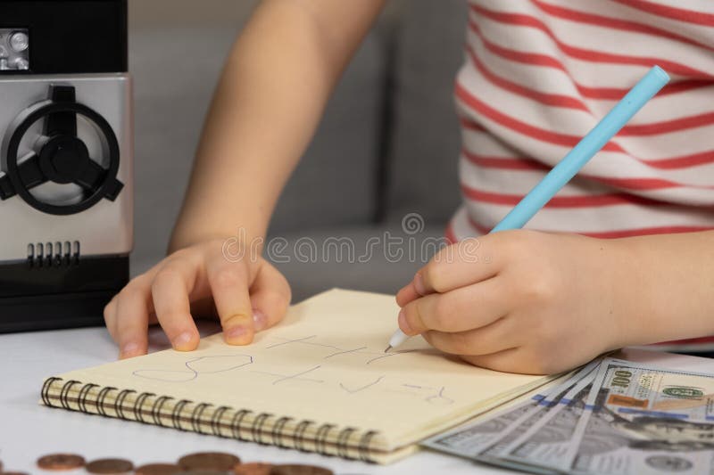 The Child Learns Financial Literacy, Writes Down His Savings in a ...