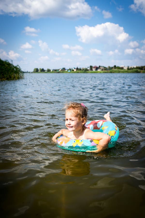 Child Learns To Swim. Child Swims in a Swimming Circle Stock Photo ...