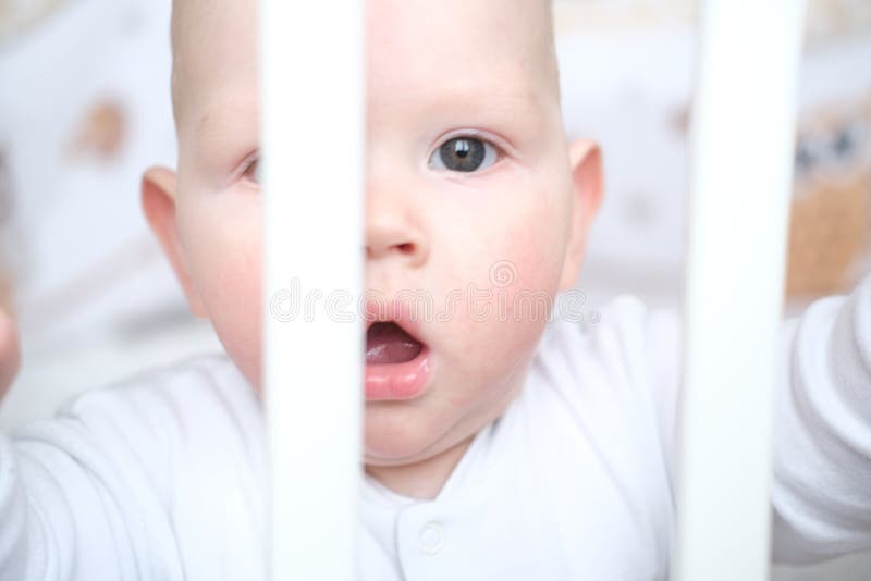 The Child Learns To Walk in a Crib and Takes the First Steps Stock ...