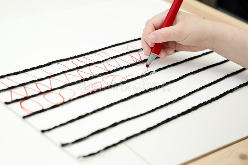 Child Learns To Write Symbols. Hand Training Tasks. Stock Image - Image ...