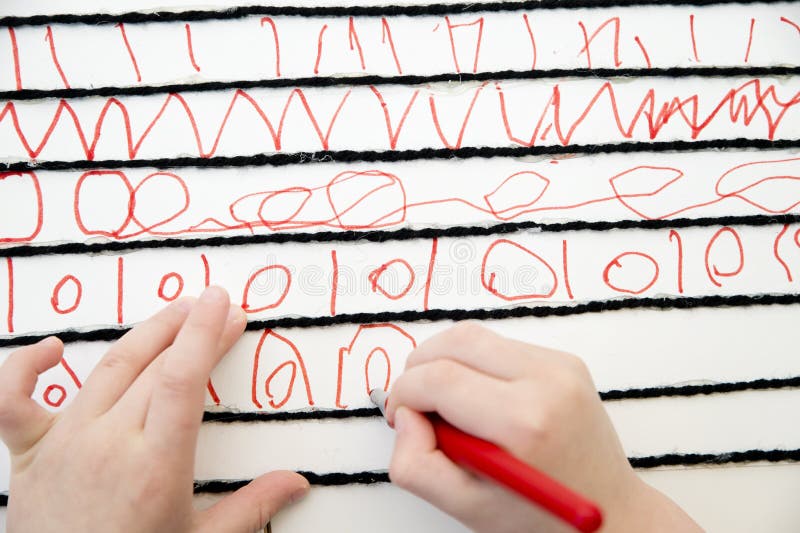 Child Learns To Write Symbols. Hand Training Tasks. Stock Image - Image ...