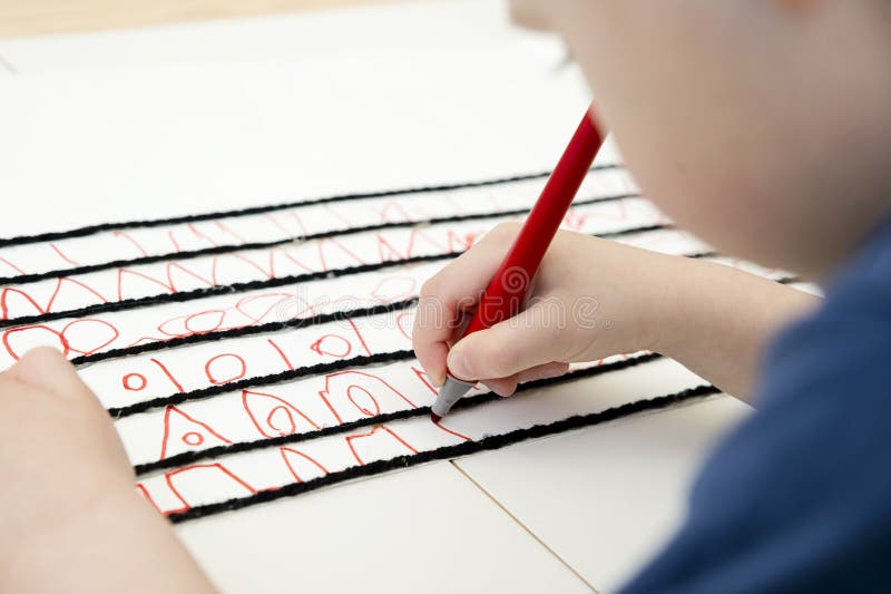 Child Learns To Write Symbols. Hand Training Tasks Stock Image - Image ...
