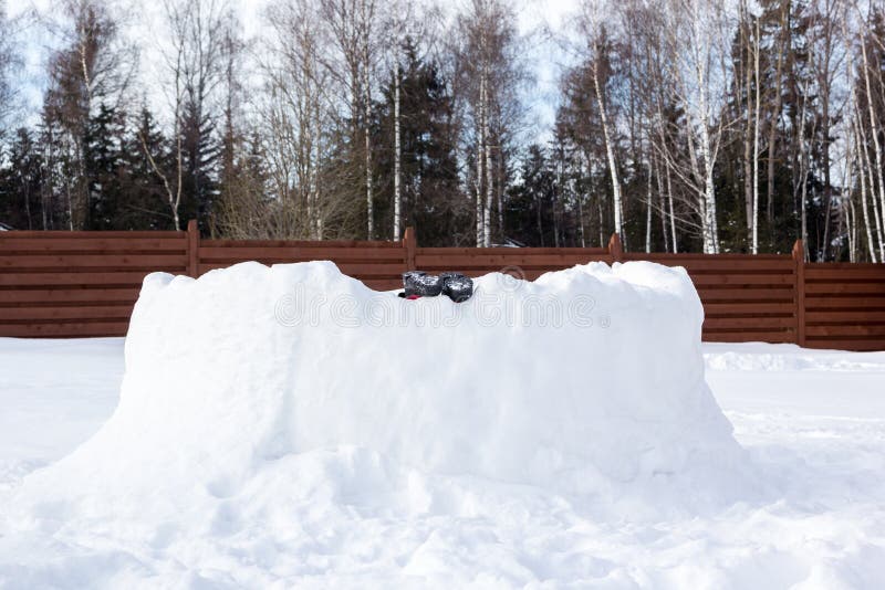 Child Legs Stick Out of the Wall of Snow Fortress Stock Image - Image ...